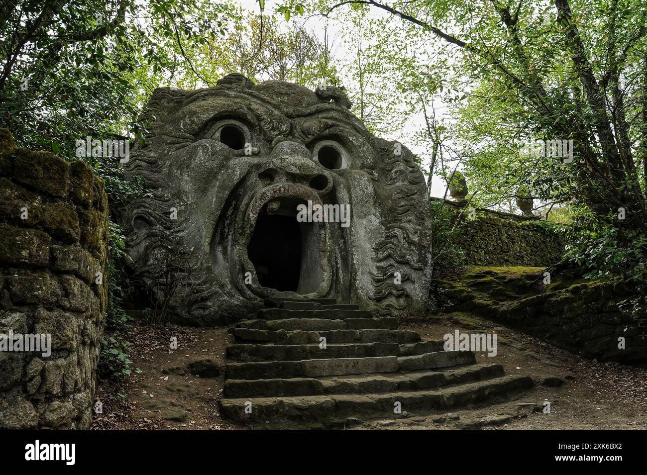 Ancient stone sculpture of a monstrous face with an open mouth also ...
