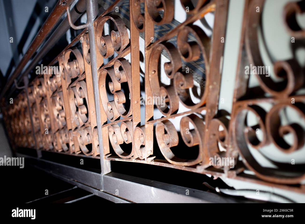A view of an antique iron staircase railing design with dramatic ...