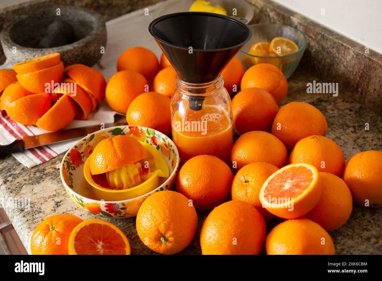 A view of a counter filled with cara cara oranges and the process of ...