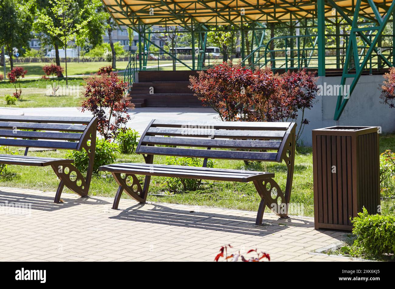 Rest area with bench surrounded by blooming trees and ornamental shrubs ...