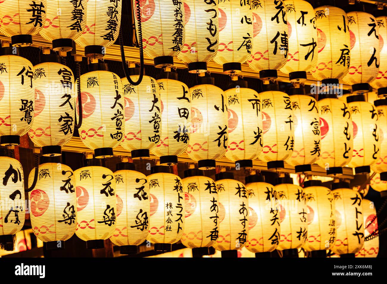 Rows of traditional Japanese paper lanterns, glowing warmly at night ...