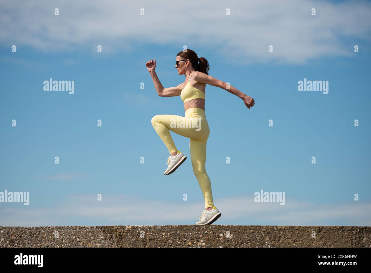 Running woman wearing blue hi-res stock photography and images - Alamy