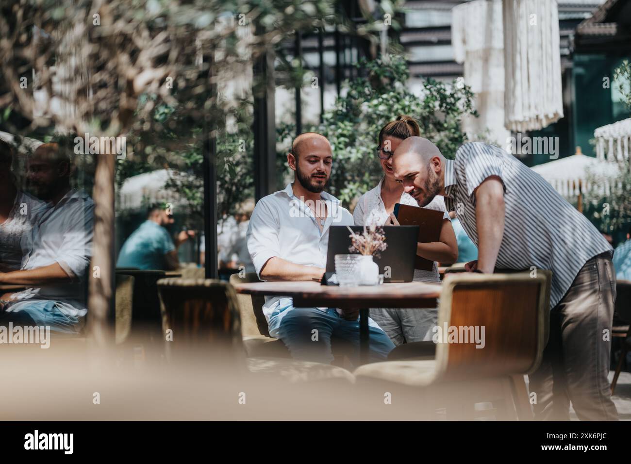 Business workers collaborating in a coffee bar on a project ...