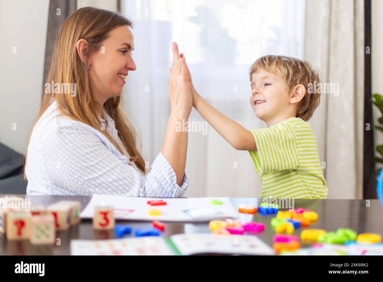 Happy mother giving high five hi-res stock photography and images - Alamy