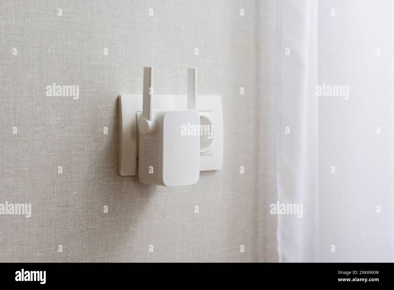 Modern WiFi Range Extender Plugged into Wall Outlet Stock Photo - Alamy