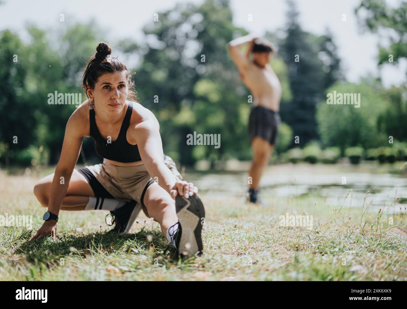 Outdoor workout with two fit individuals exercising in a park during ...