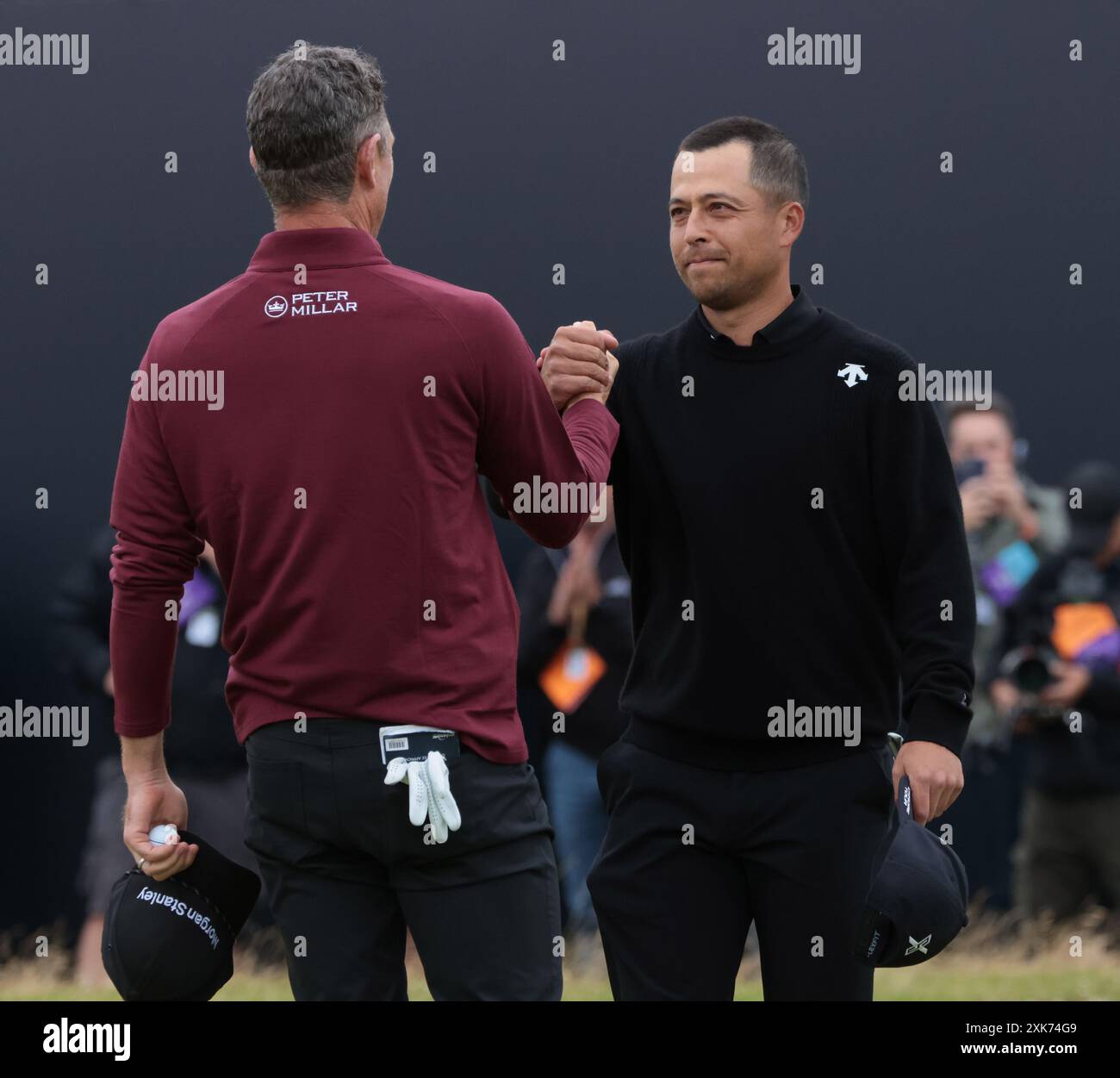 Troon, UK. 21st July, 2024. American Xander Schauffele is congratulated by fellow golfer Justin ...