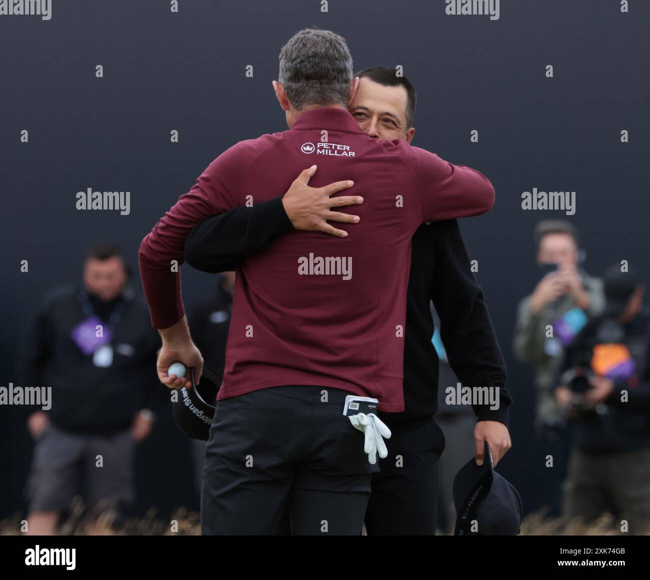 Troon, UK. 21st July, 2024. American Xander Schauffele is congratulated by fellow golfer Justin ...