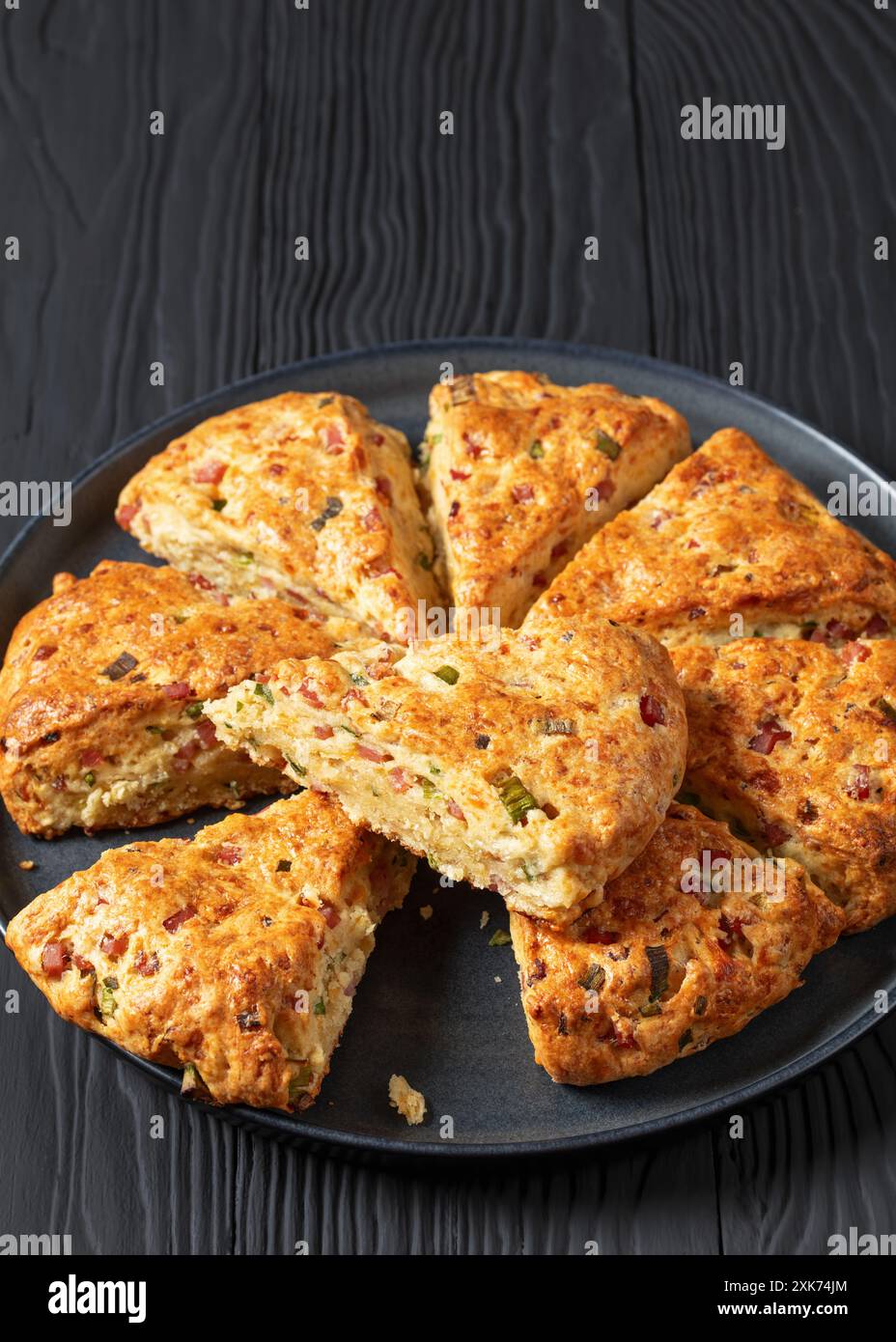 Ham and cheese triangle american scones on grey platter on black wooden ...