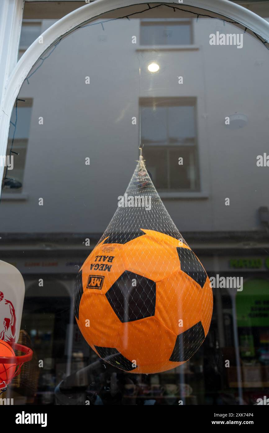 Orange football in net in shop display hi-res stock photography and ...