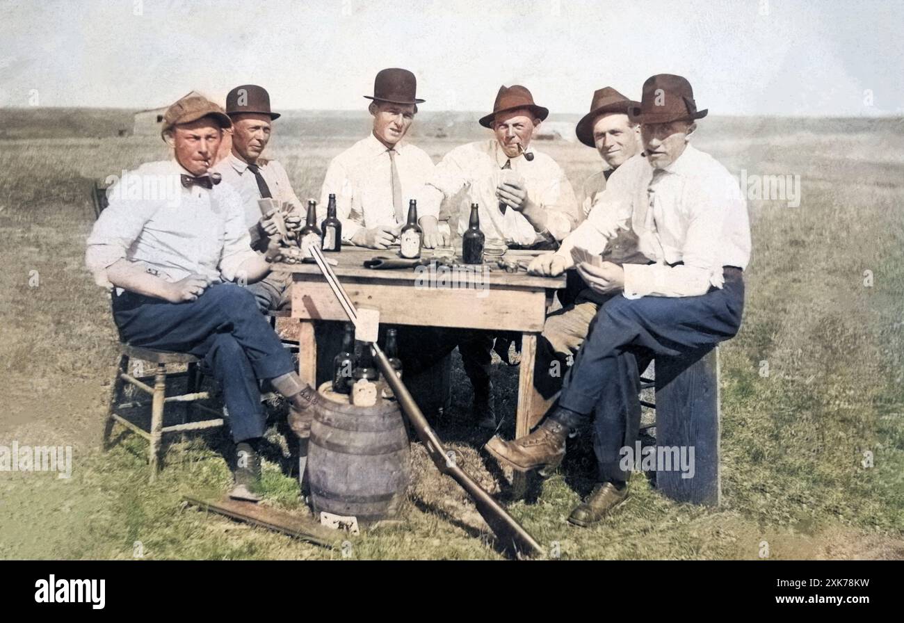 Six men sitting outdoors, wearing hats, gambling, drinking and playing ...