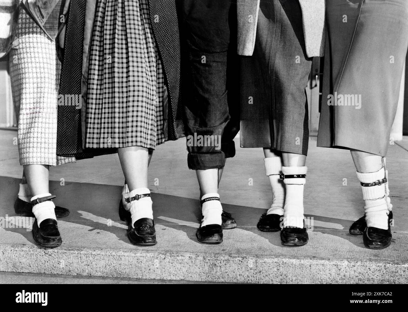 Legs and feet of five teenage girls wearing dog collar anklets on their ...
