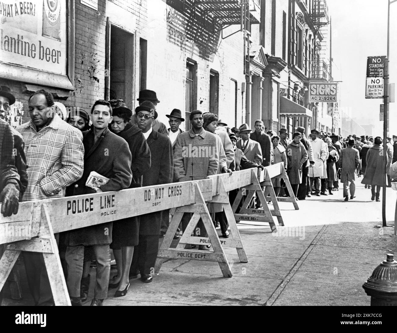 Group of people lined up to pay their respects at the funeral of ...