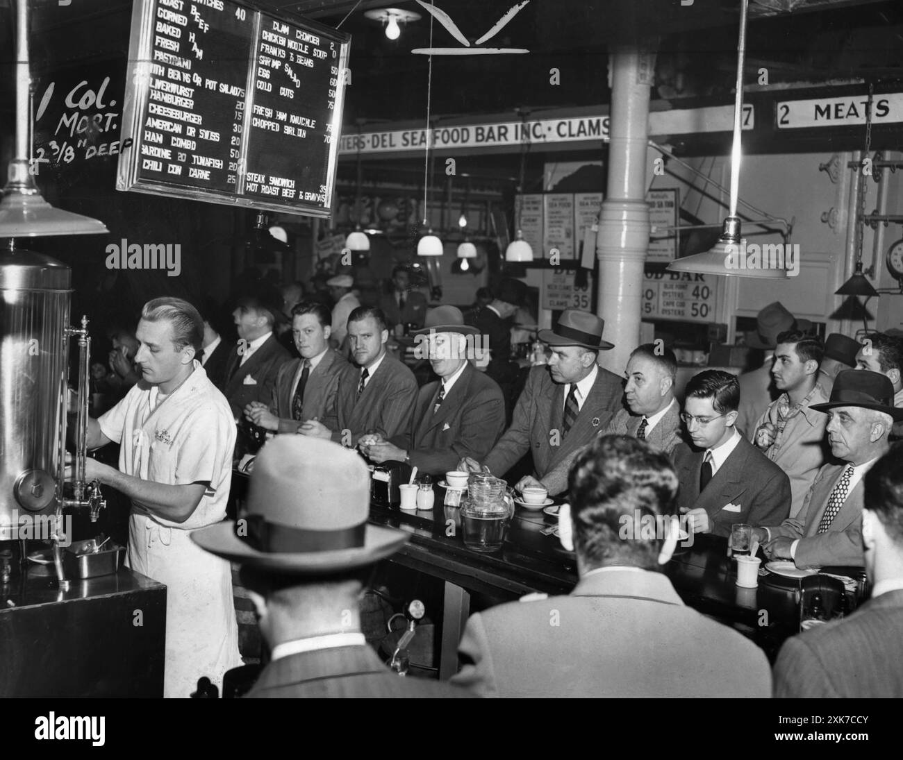 Group of men eating and drinking at Pete's Bar, Washington Market, New ...