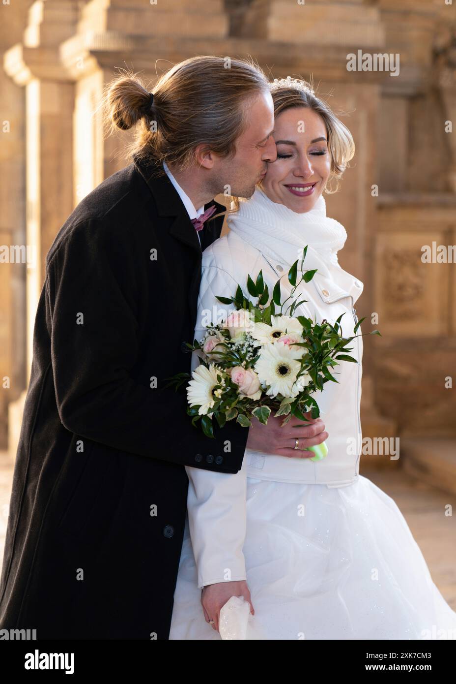 Wedding romantic moment. The groom lovingly kisses the bride. The bride ...
