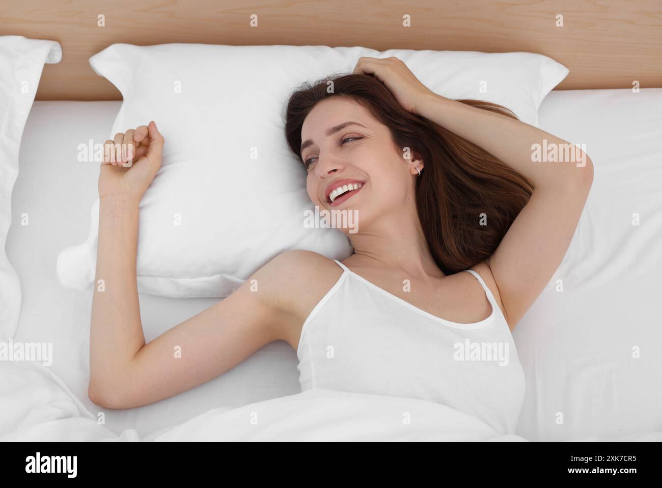 Happy woman lying in bed hi-res stock photography and images - Alamy