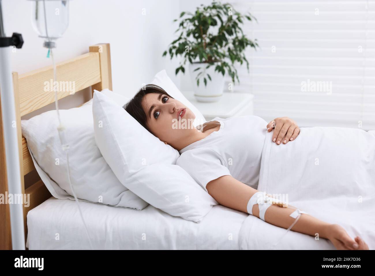 Young woman with intravenous drip in hospital bed Stock Photo - Alamy