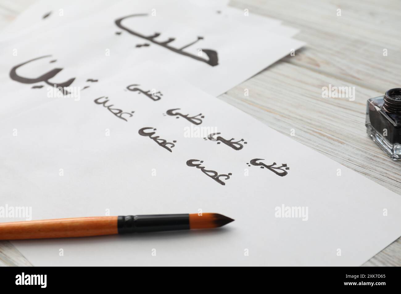 Calligraphy. Papers with word Branch in Arabian language and brush on ...