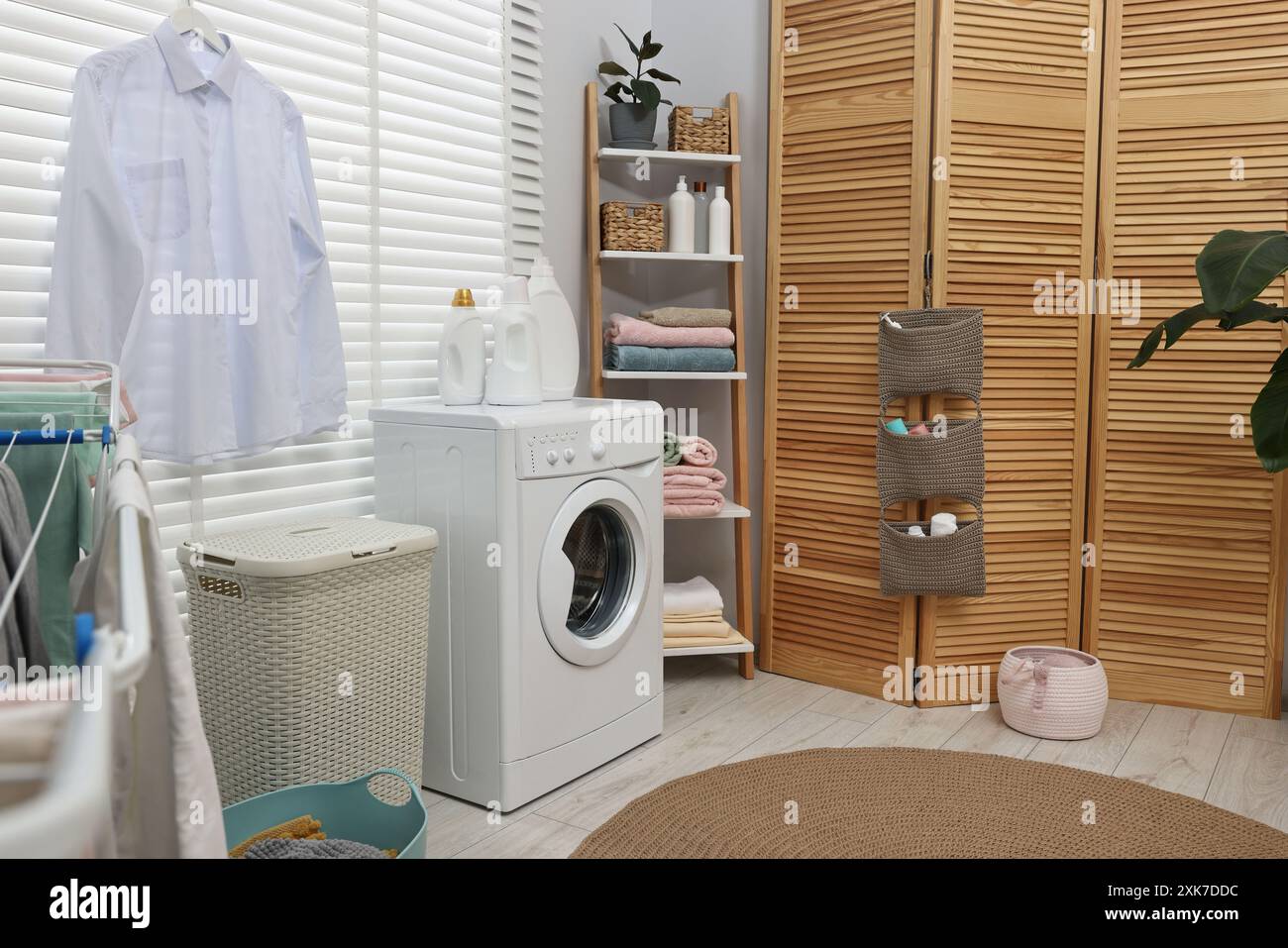 Washing machine, folding screen, detergents, towels and basket in ...