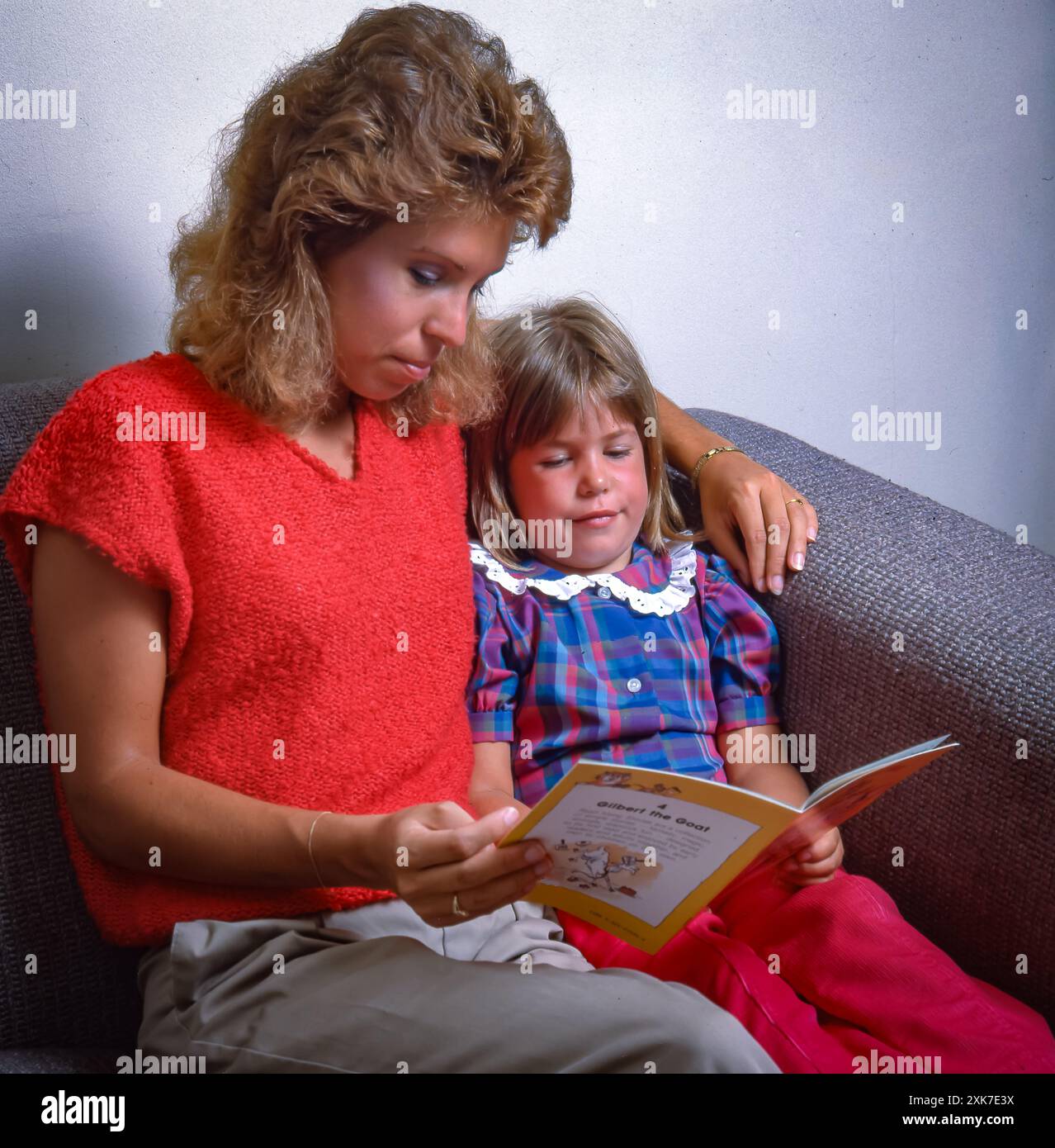 Child, parent reading book together Stock Photo - Alamy