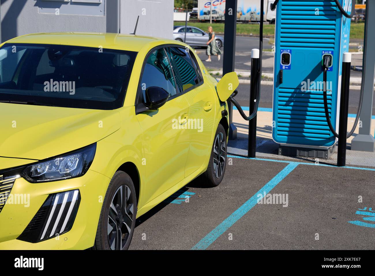Electric car battery charging in the parking lot of a Carrefour ...