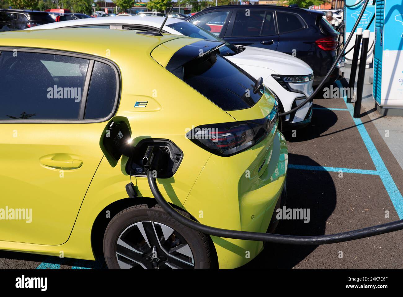 Electric car battery charging in the parking lot of a Carrefour ...