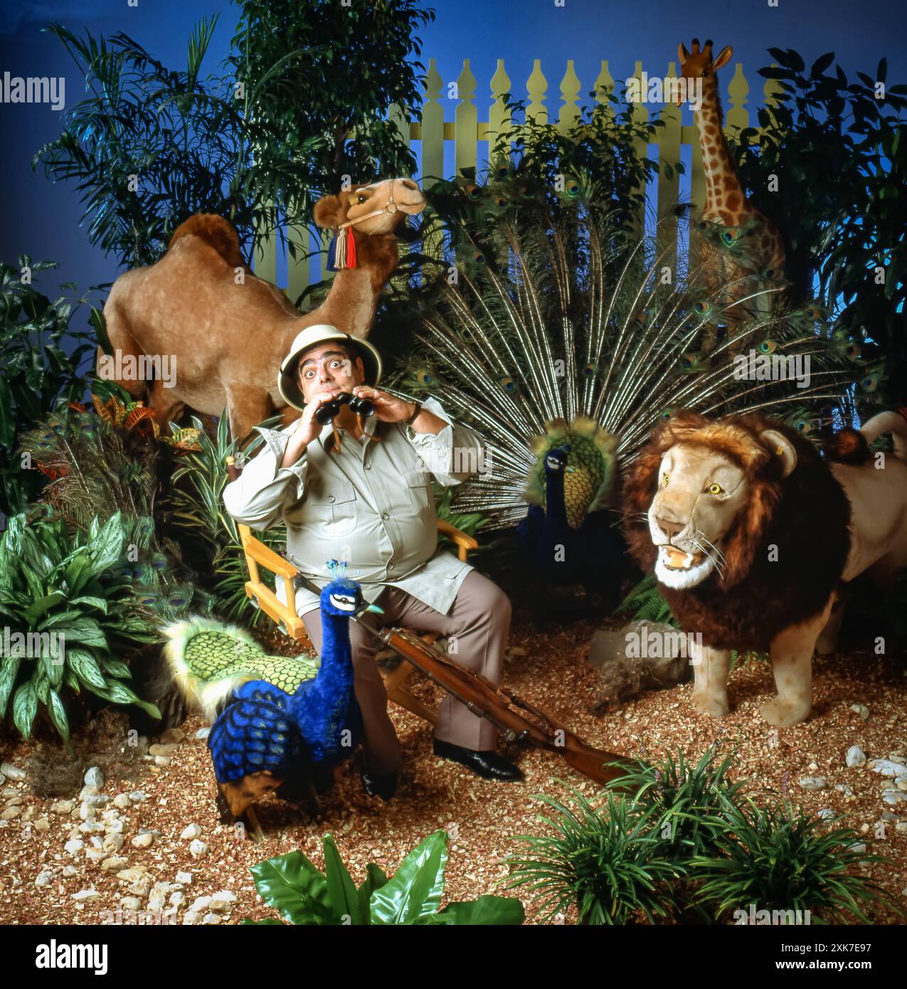 Safari scene with toy stuffed animals in jungle setting . Humor, kitsch ...