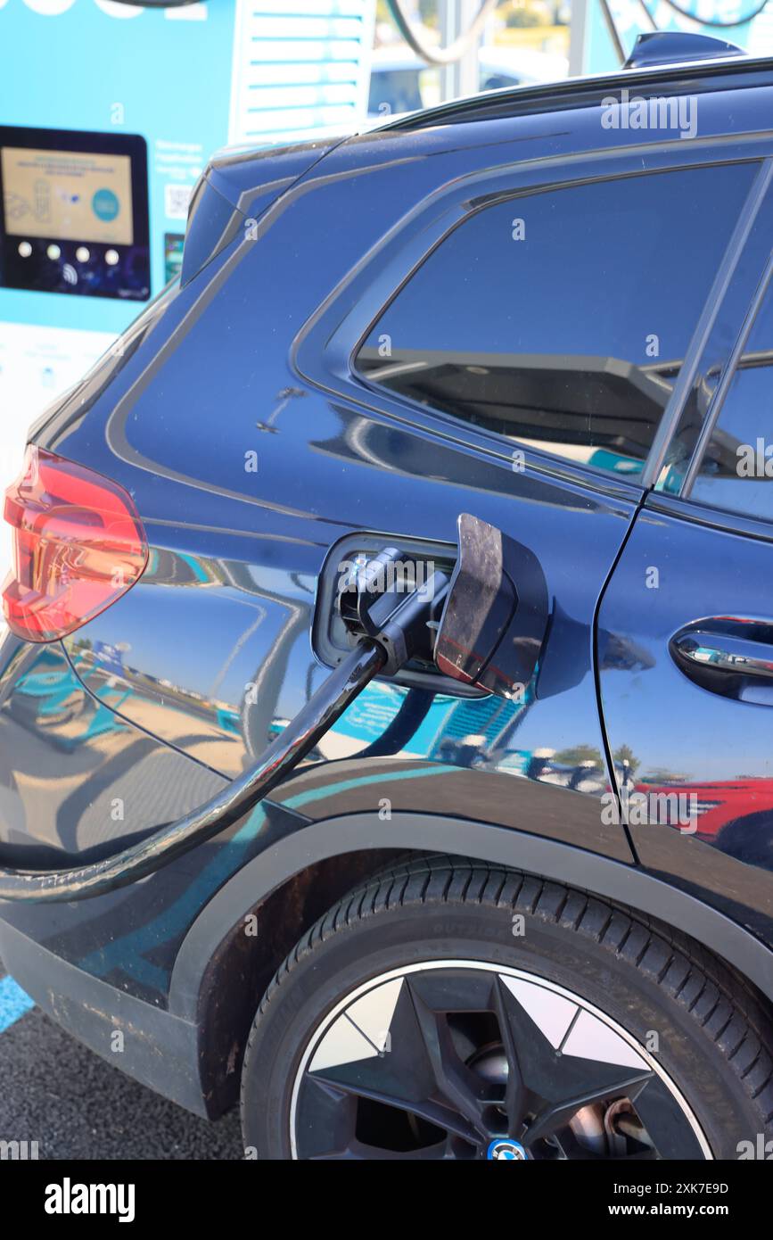 Electric car battery charging in the parking lot of a Carrefour ...