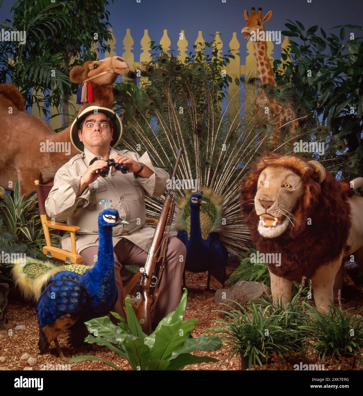 Safari scene with toy stuffed animals in jungle setting . Humor, kitsch ...