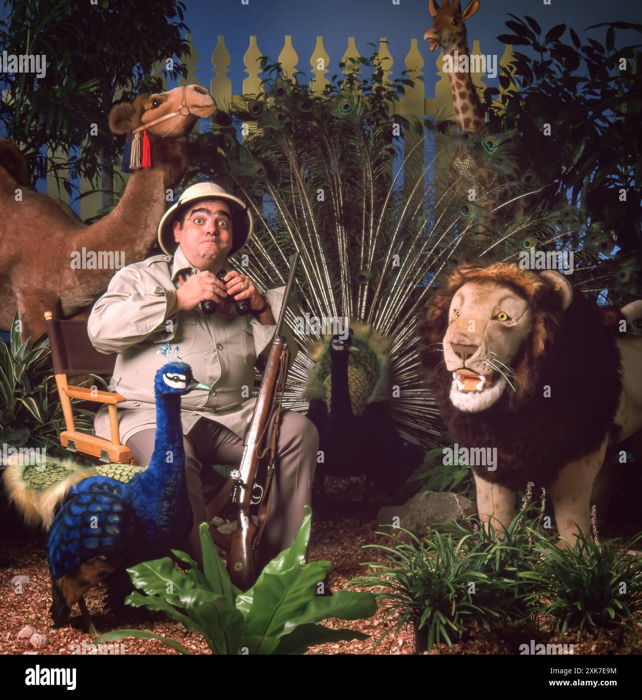 Safari scene with toy stuffed animals in jungle setting . Humor, kitsch ...
