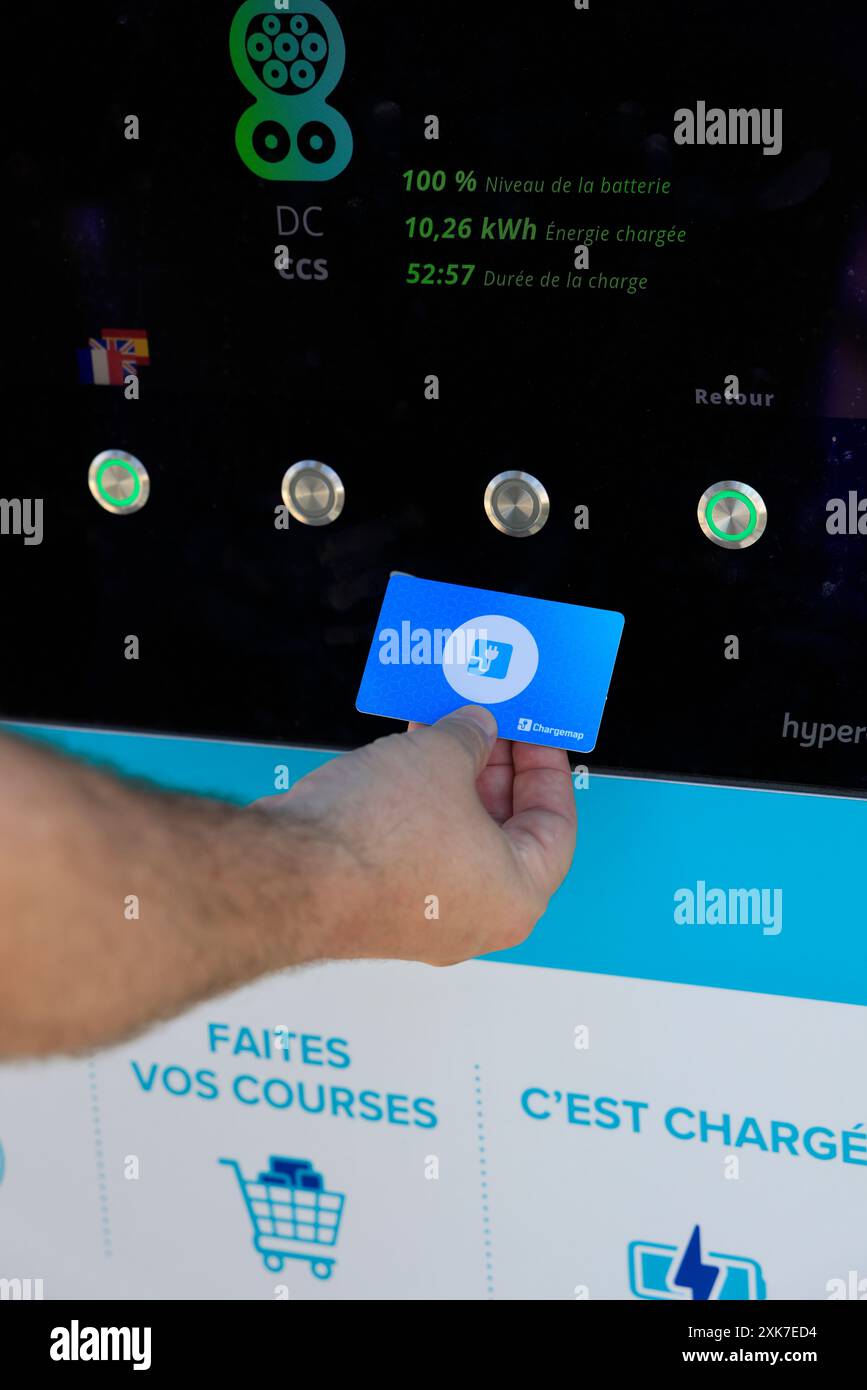 Electric car battery charging in the parking lot of a Carrefour ...