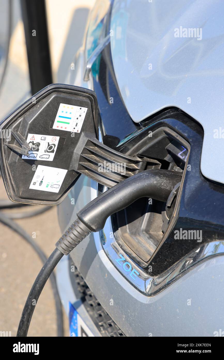 Electric car battery charging in the parking lot of a Carrefour ...