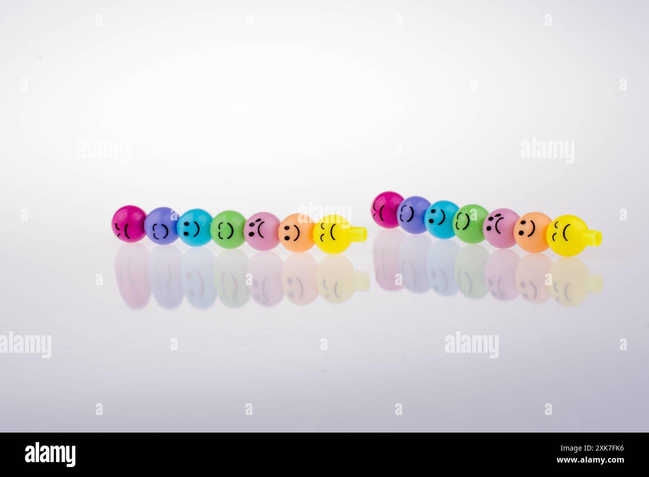 Color beads with facial expression on white background Stock Photo - Alamy