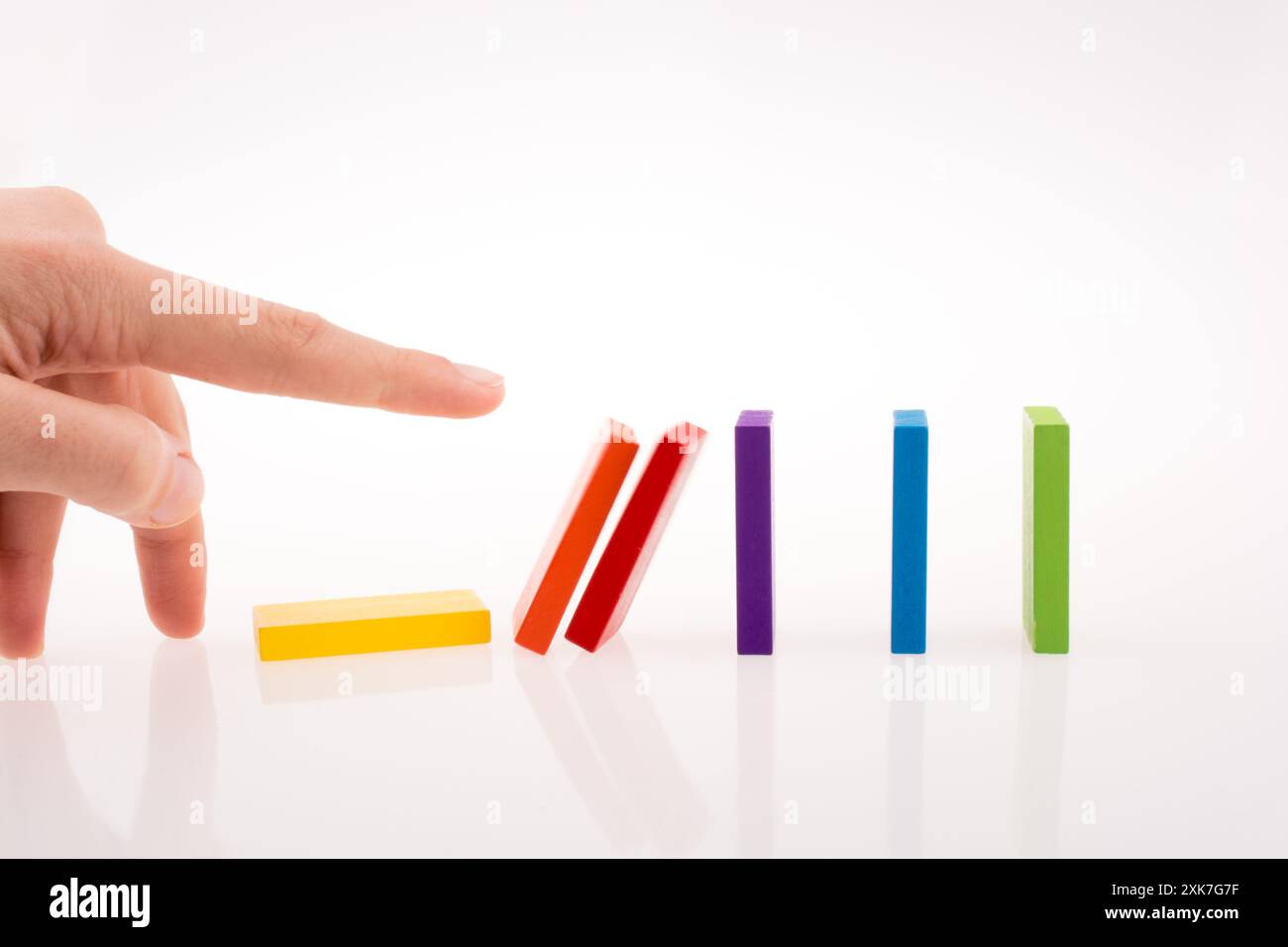 Hand playing with colored domino on white background Stock Photo - Alamy