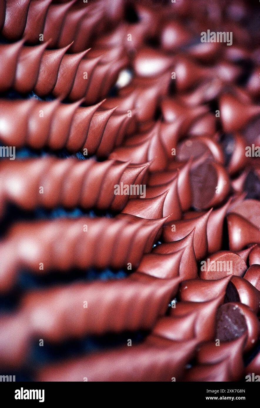 Close-up of Hershey Kiss candy on conveyor belt; ; Hershey ...