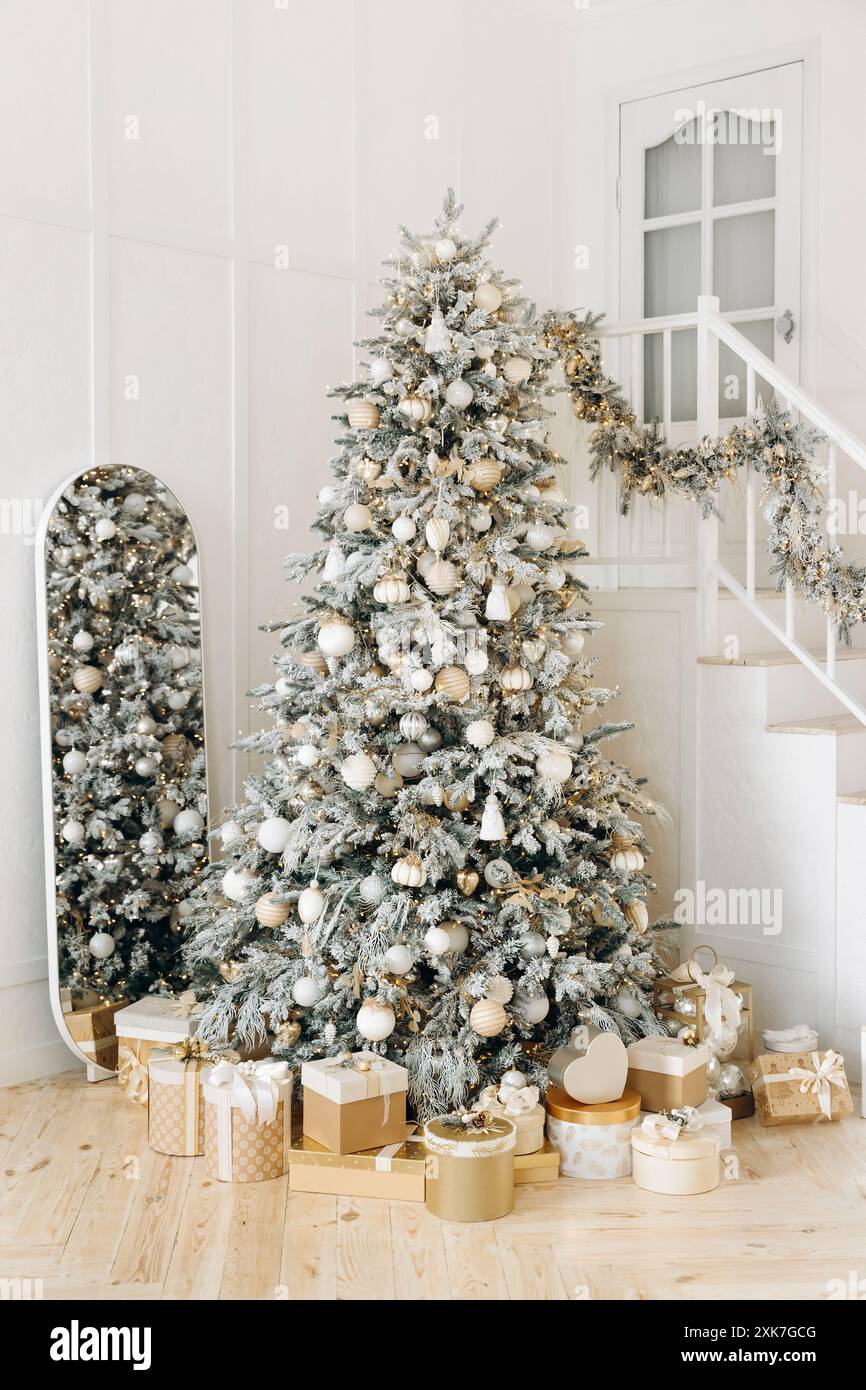 Elegant Christmas setup with a decorated tree and a variety of gifts in ...