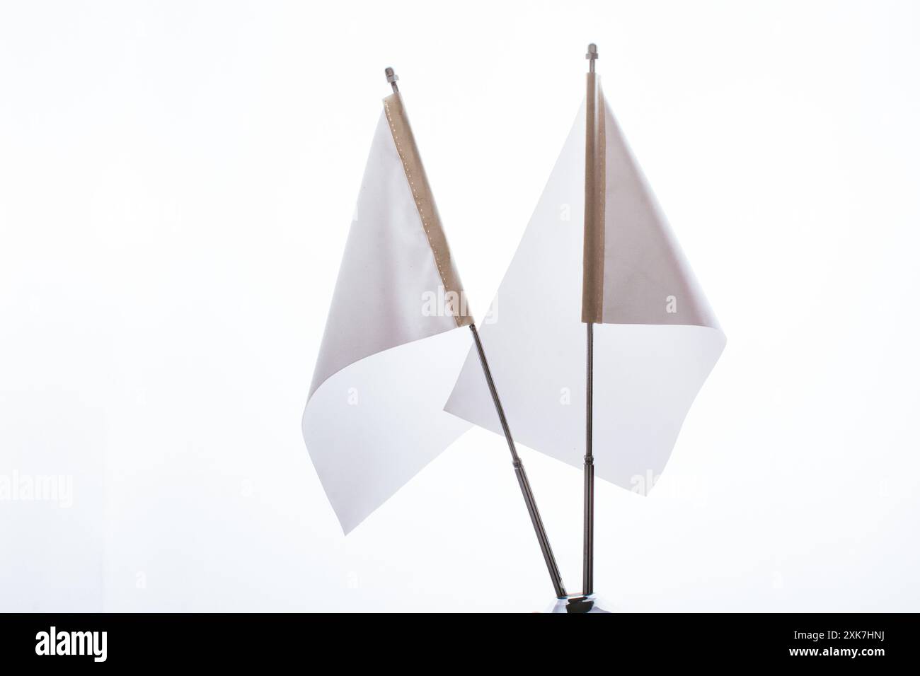 Two white flags on a white background in the display Stock Photo - Alamy