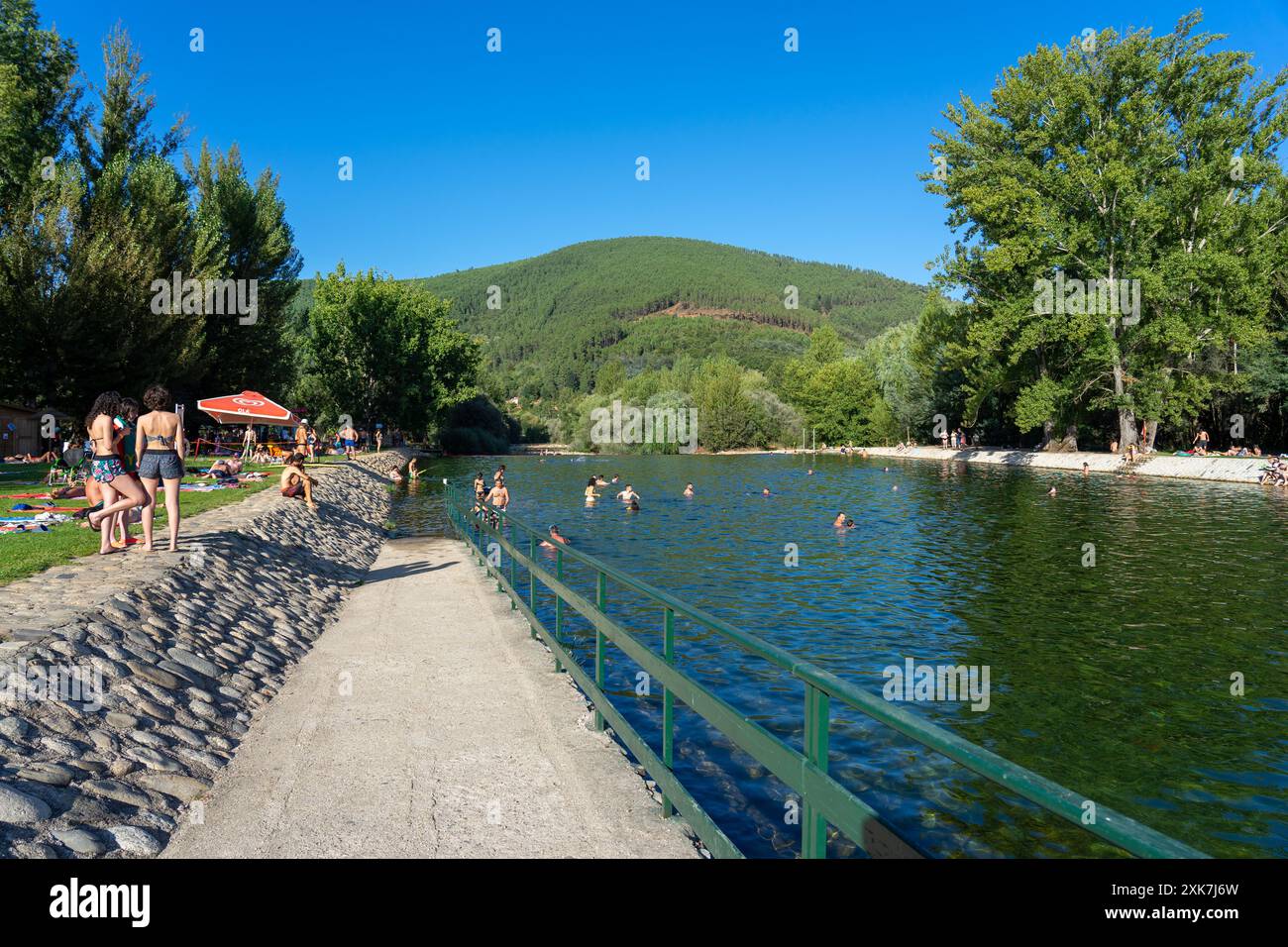 River beach in the town of Valhelhas surrounded by green mountains near ...