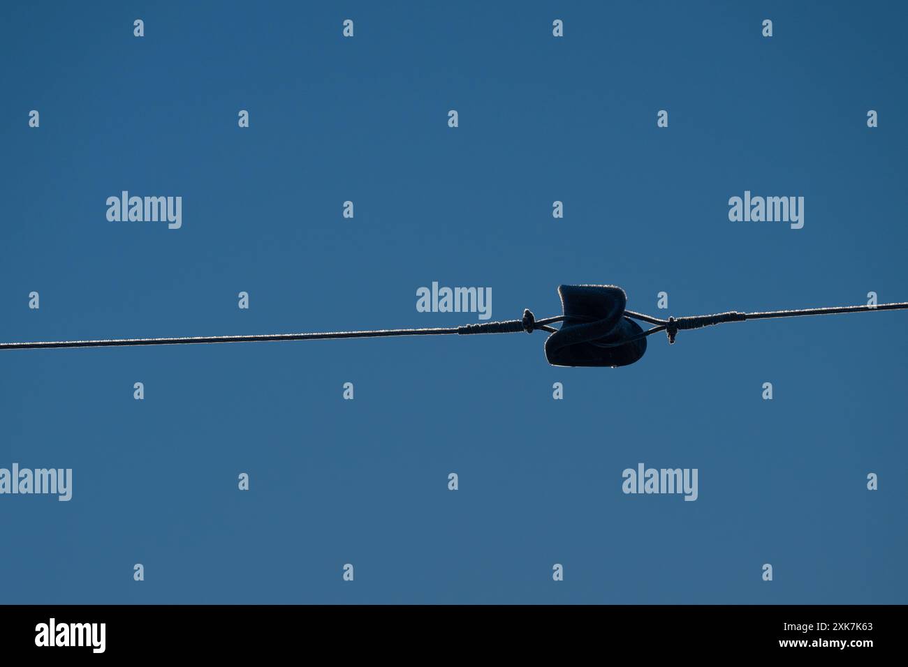 Power line tensioner in the middle of a span Stock Photo - Alamy