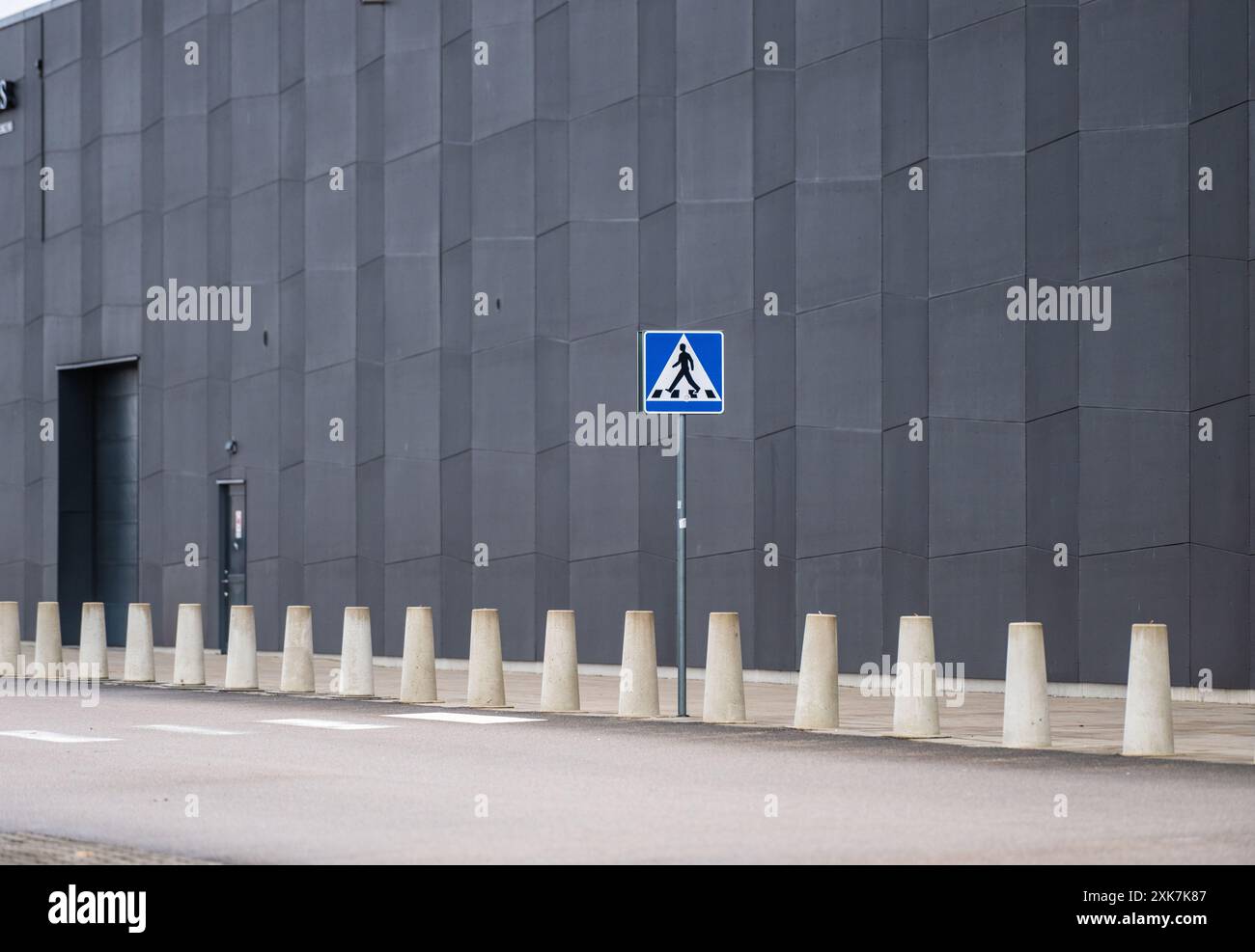Sign marking a zebra crossing by a warehouse Stock Photo - Alamy