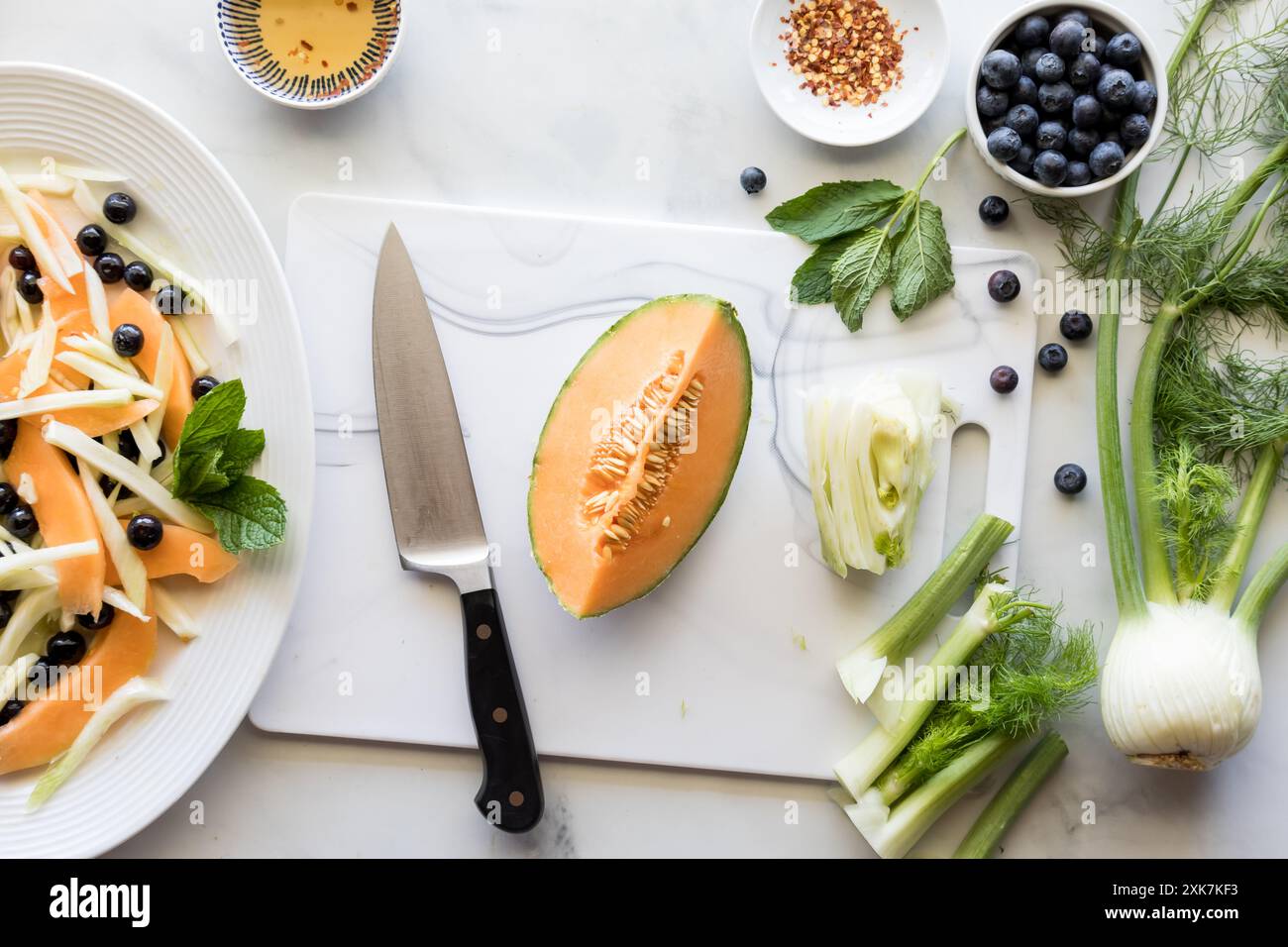 Fresh fruit and vegetables to make a fennel, melon and berry salad ...