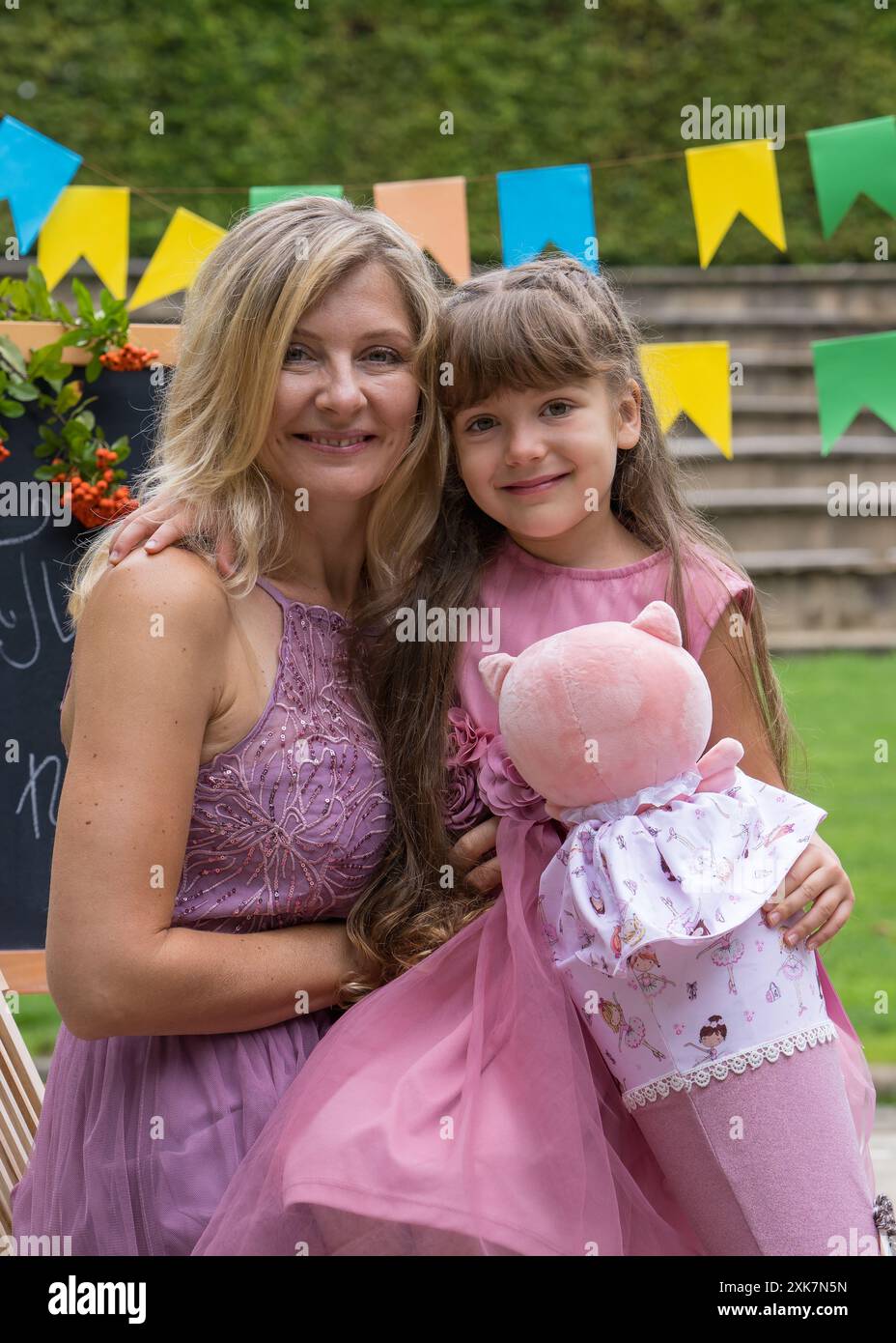 Mom tightly hugs her little daughter, who went to 1st grade. The girl ...