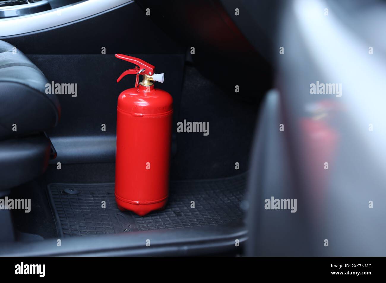 Red fire extinguisher in automobile. Car safety equipment Stock Photo ...