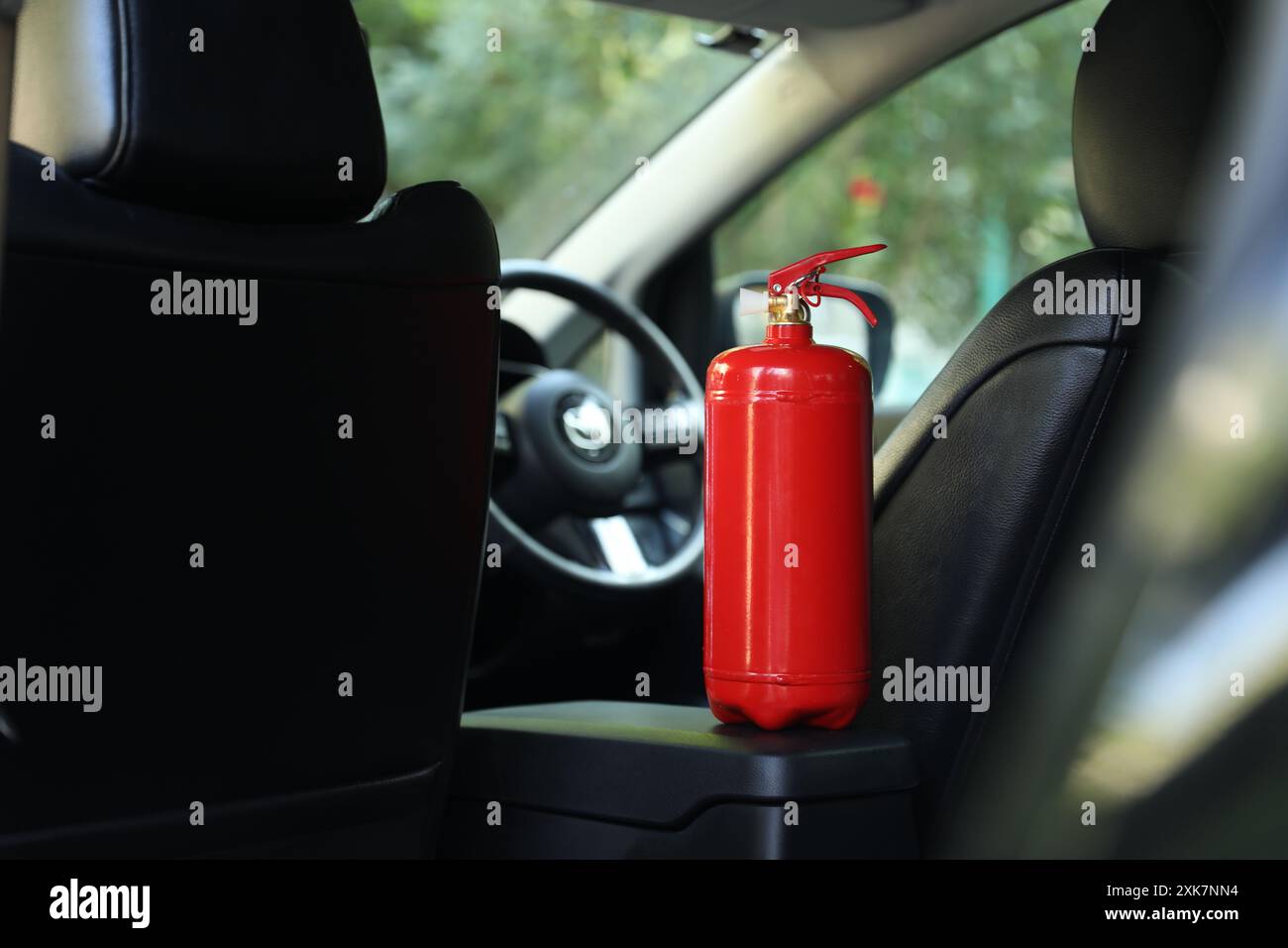 Red fire extinguisher in automobile. Car safety equipment Stock Photo ...