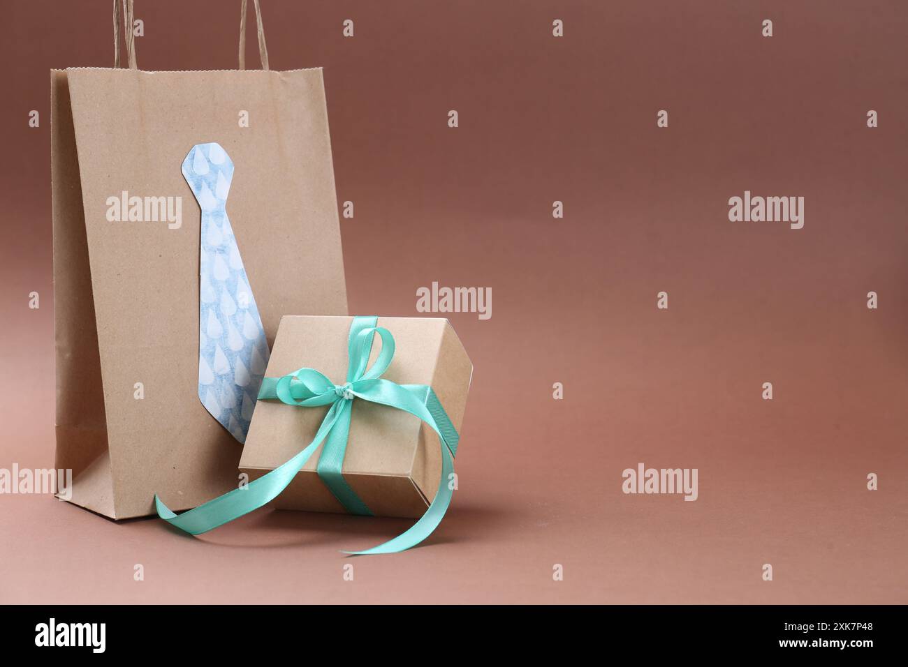 Happy Father's Day. Paper bag with tie and gift box on light brown ...