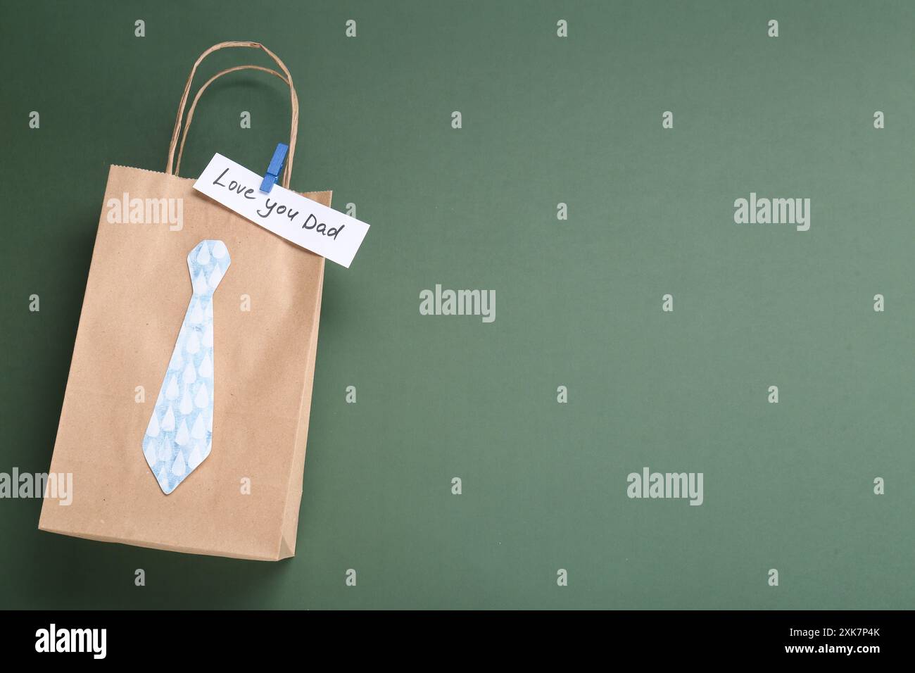 Happy Father's Day. Paper bag with tie and phrase Love You Dad on green ...