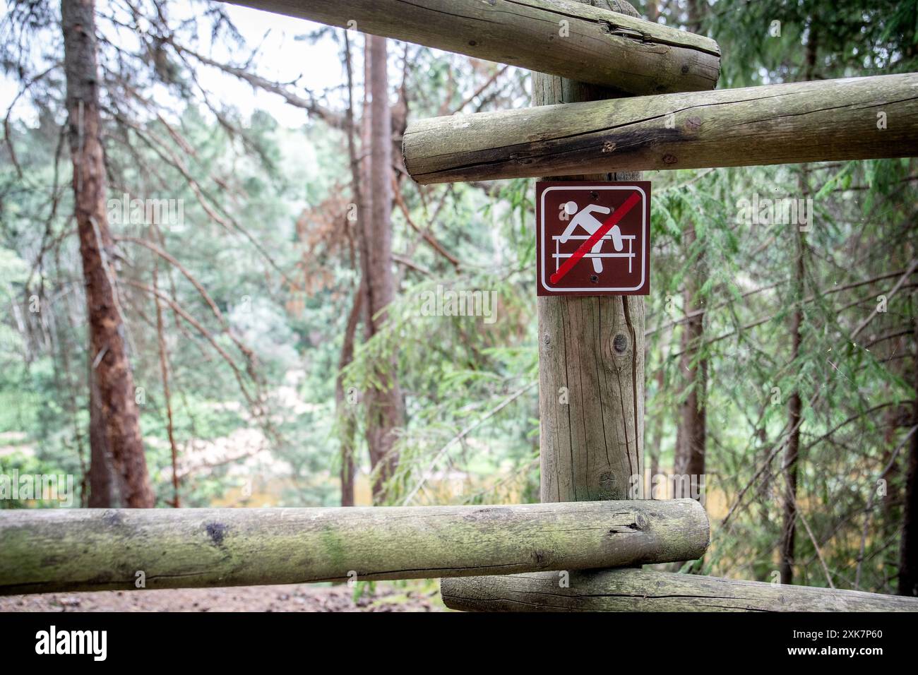 Warning sign at the wooden railing that climb over is not allowed Stock ...