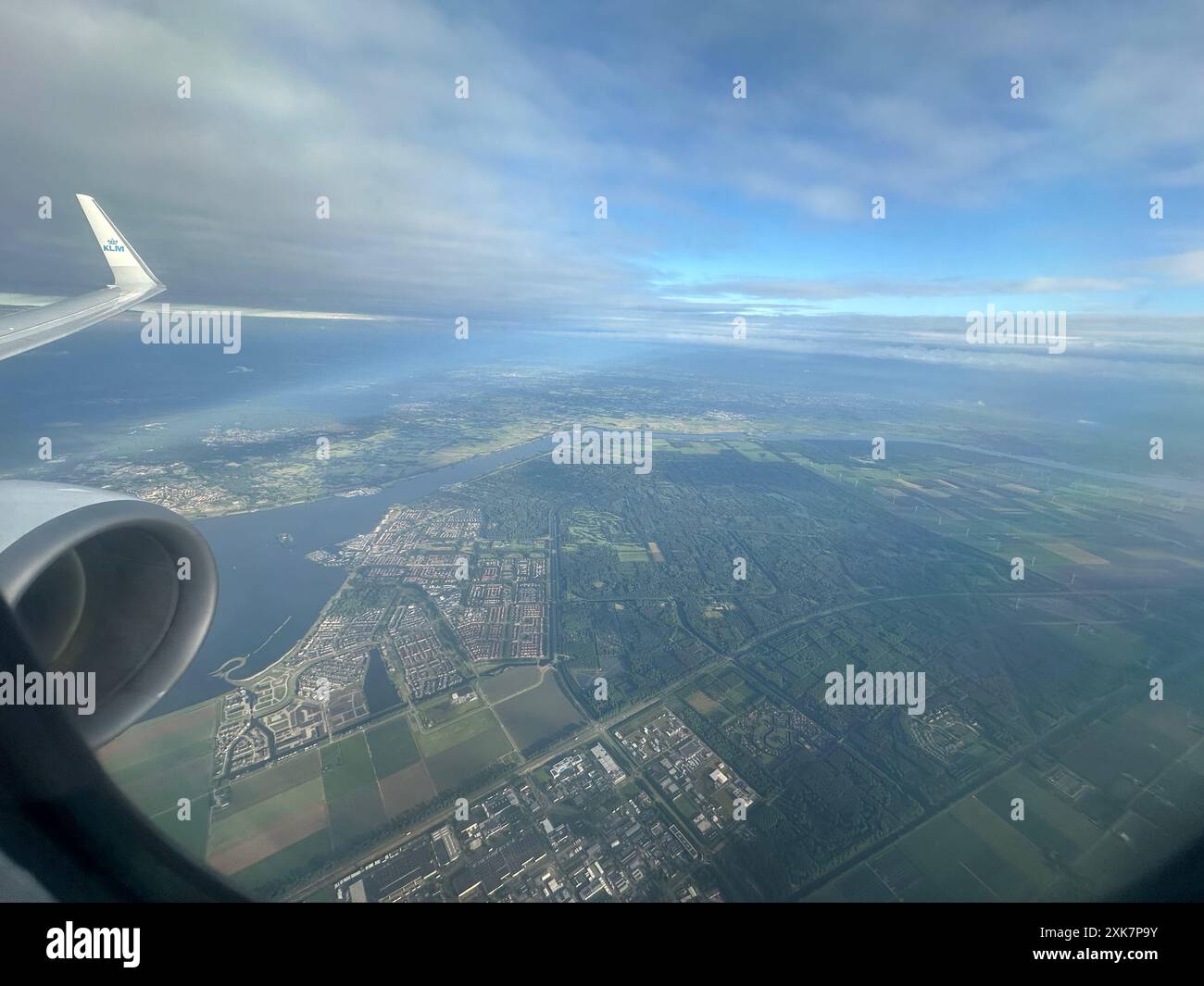 Picturesque view of city through plane window during flight Stock Photo ...