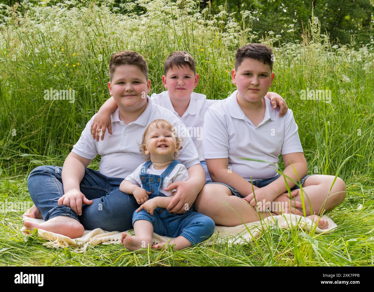 A big happy family, 4 brothers of different ages in nature, the ...