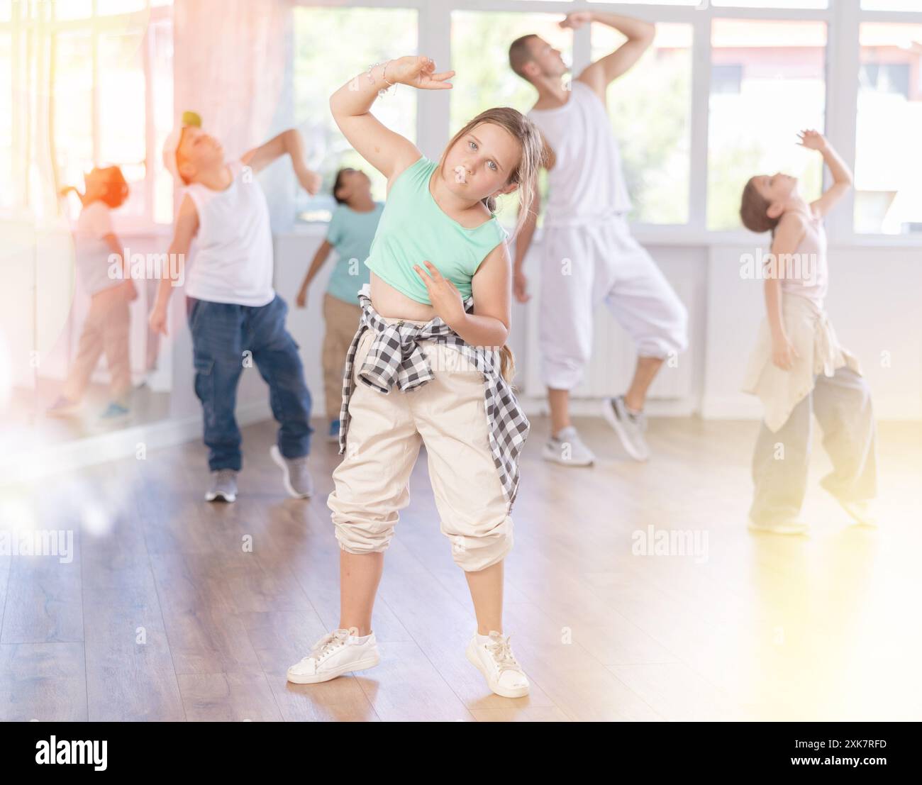 Tween girl dancer rehearsing krump dance at group workout Stock Photo ...